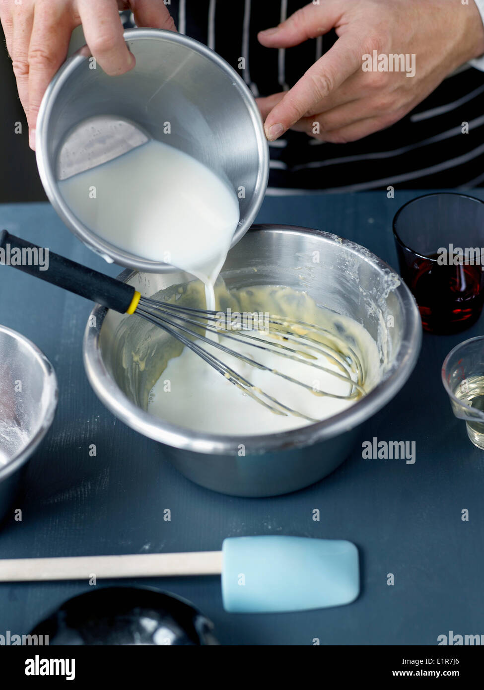 Adding the milk to the pancake batter Stock Photo - Alamy