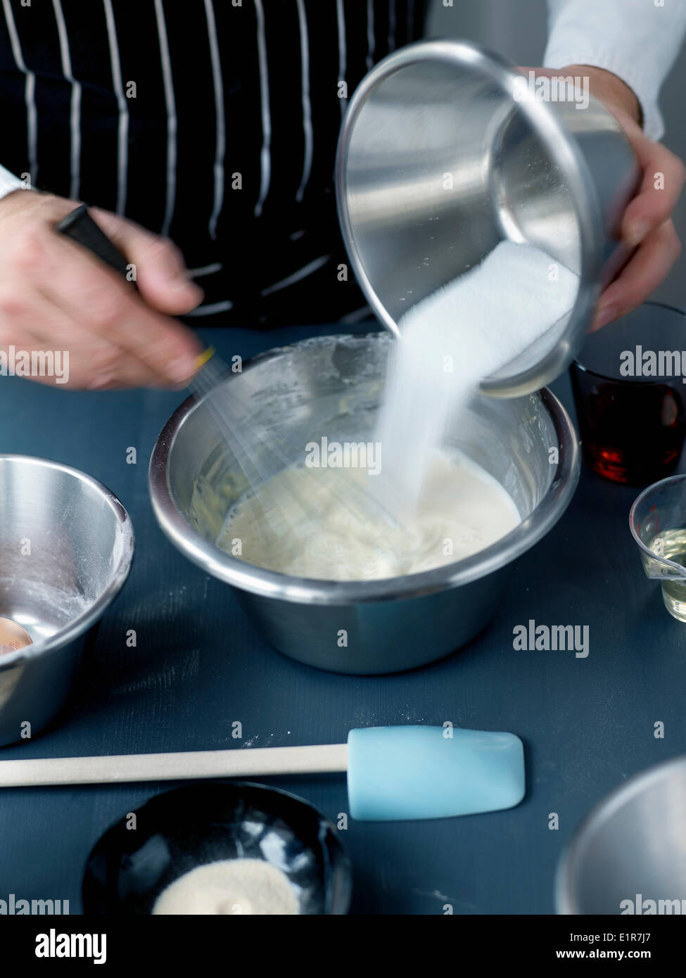 Adding the sugar to the pancake batter Stock Photo - Alamy