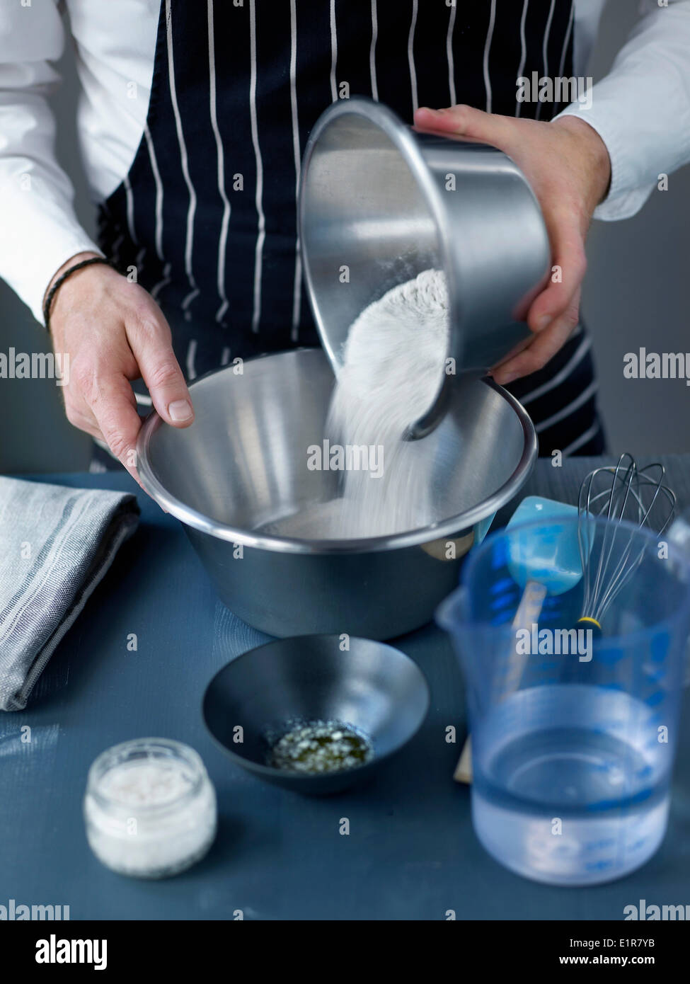 Pouring the flour into a metal bowl Stock Photo - Alamy
