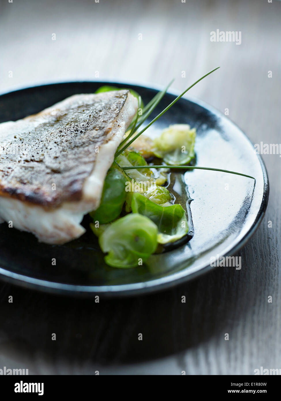 Fish fillet with brussels sprouts and soya sauce Stock Photo - Alamy