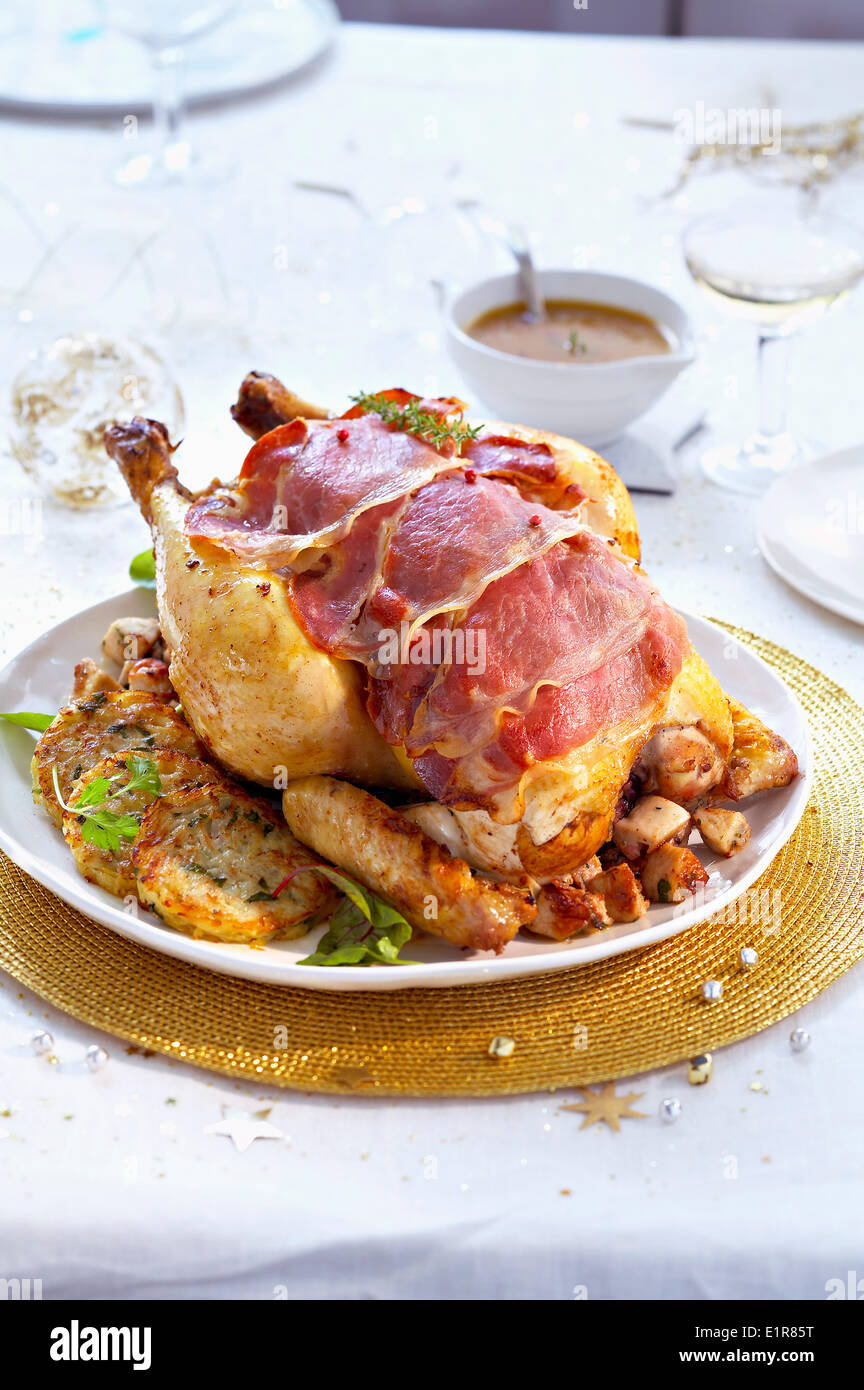 Roast capon coated with ham and stuffed with white sausage,röstis Stock ...