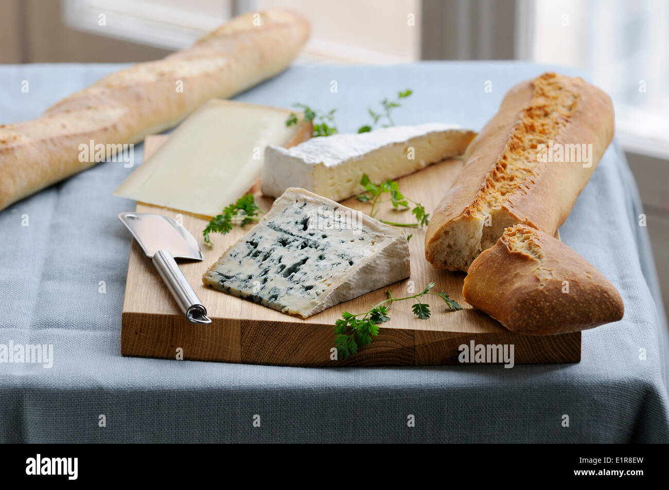 Cheeseboard with bread Stock Photo - Alamy