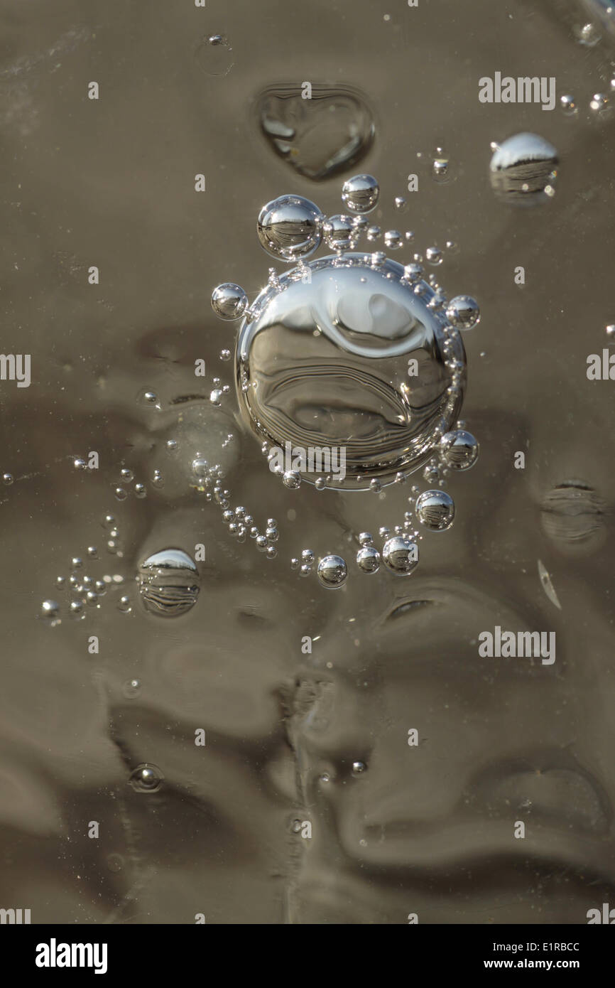 Bubbles into ice, side view Stock Photo - Alamy