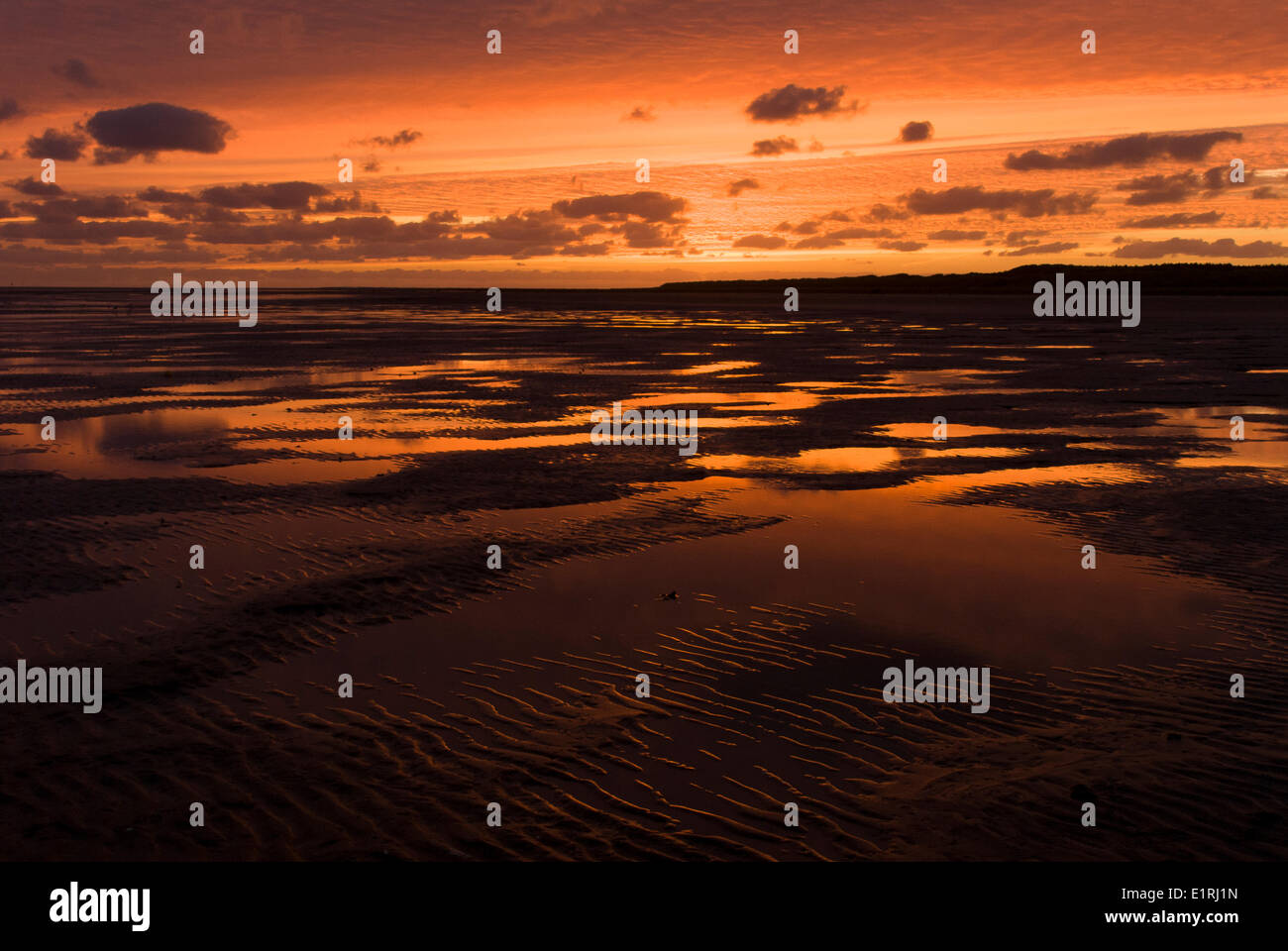Sunset over tidal pools on the beach shortly after high tide Stock ...