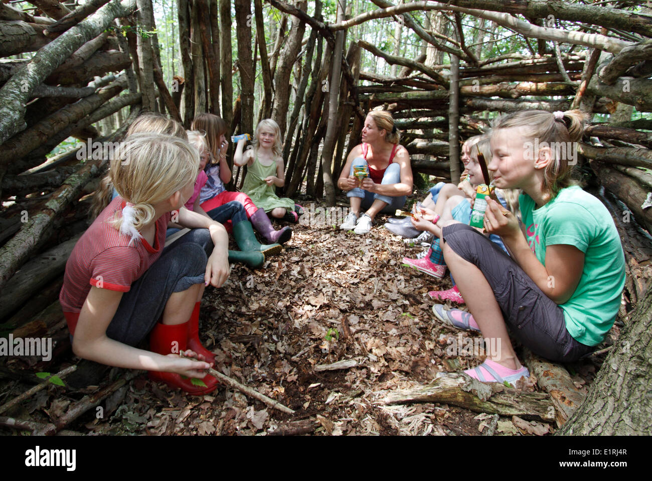 children having fun in a hut they built in a forest Stock Photo - Alamy
