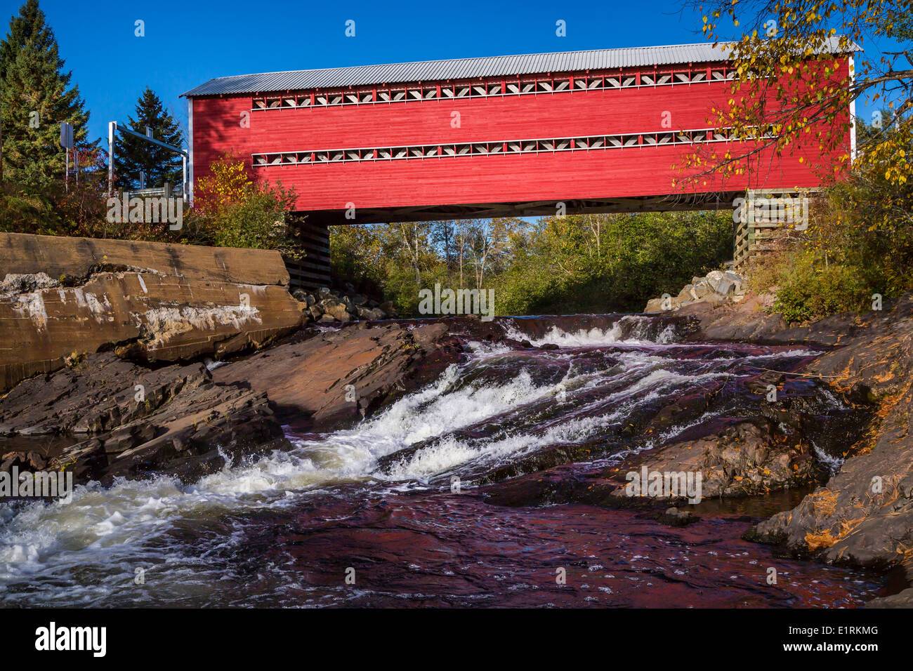 A red covered bridge, de Saint Mathieu with fall foliage color near ...