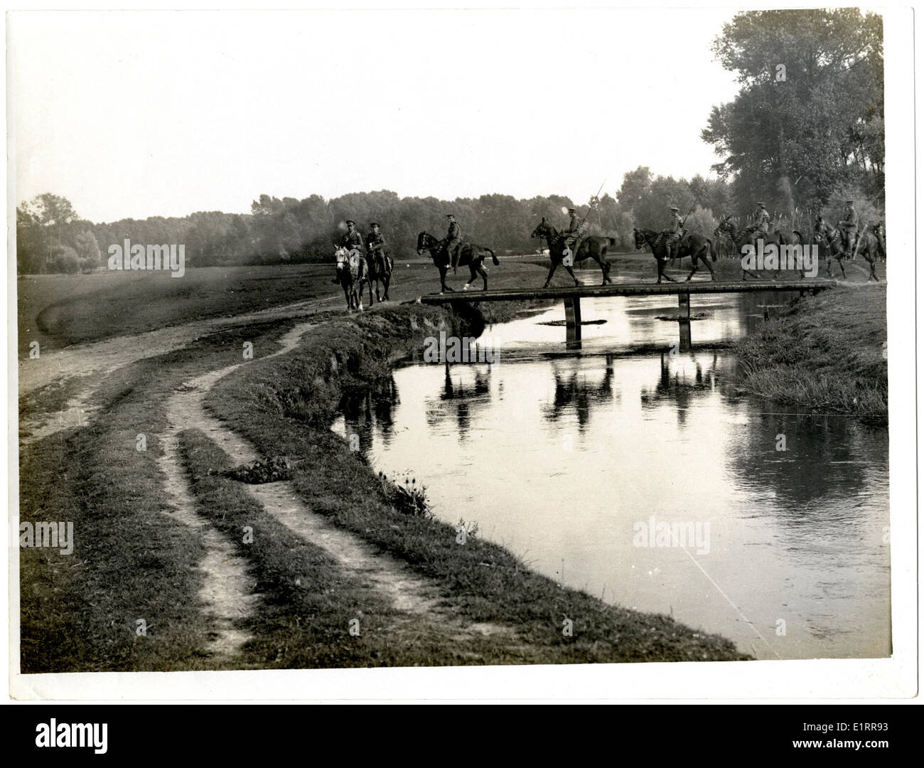 A historical photograph showing a troop of cavalry crossing a stream ...