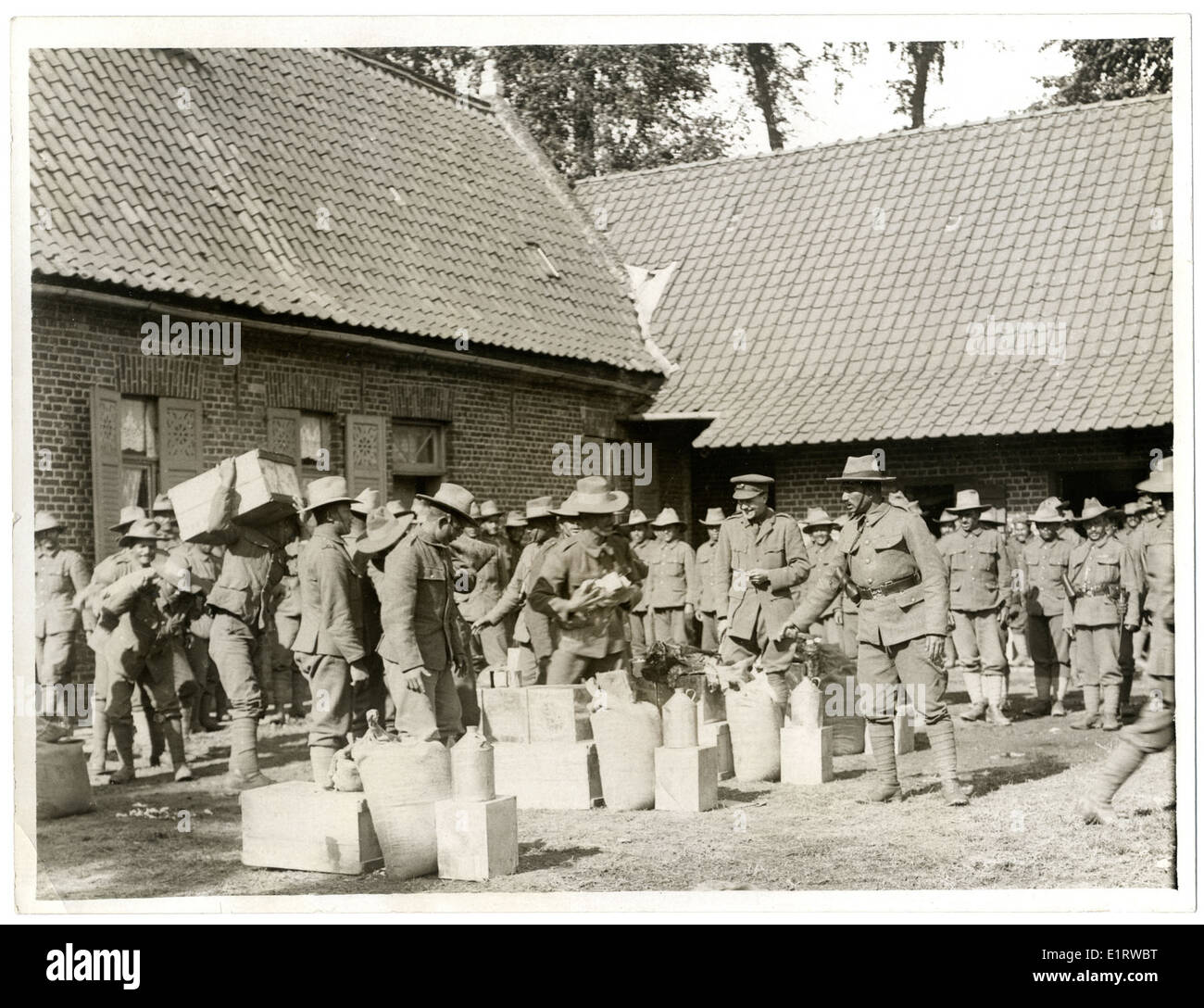 This photograph shows 9th Gurkha soldiers drawing rations at a French ...