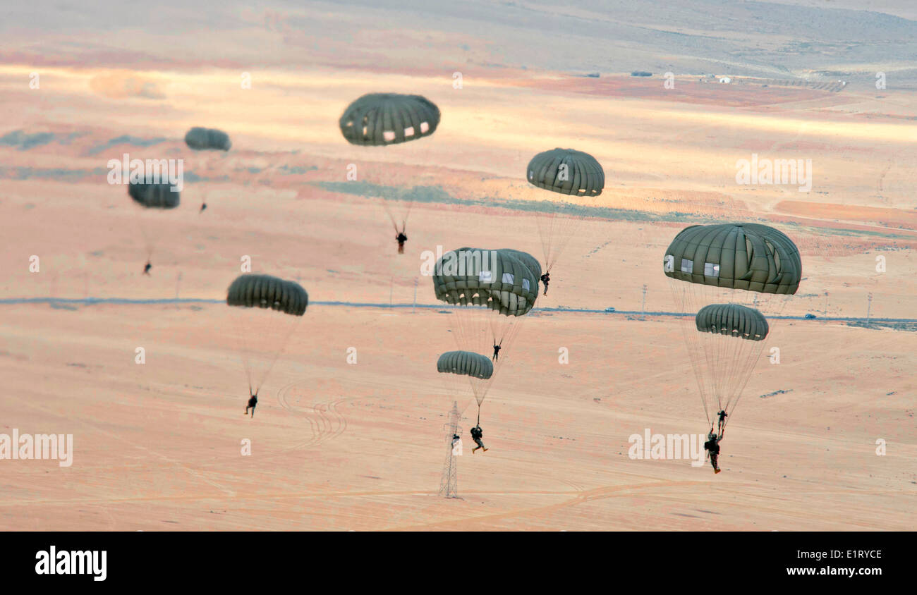 Paratroopers from various countries descend over the desert during a ...