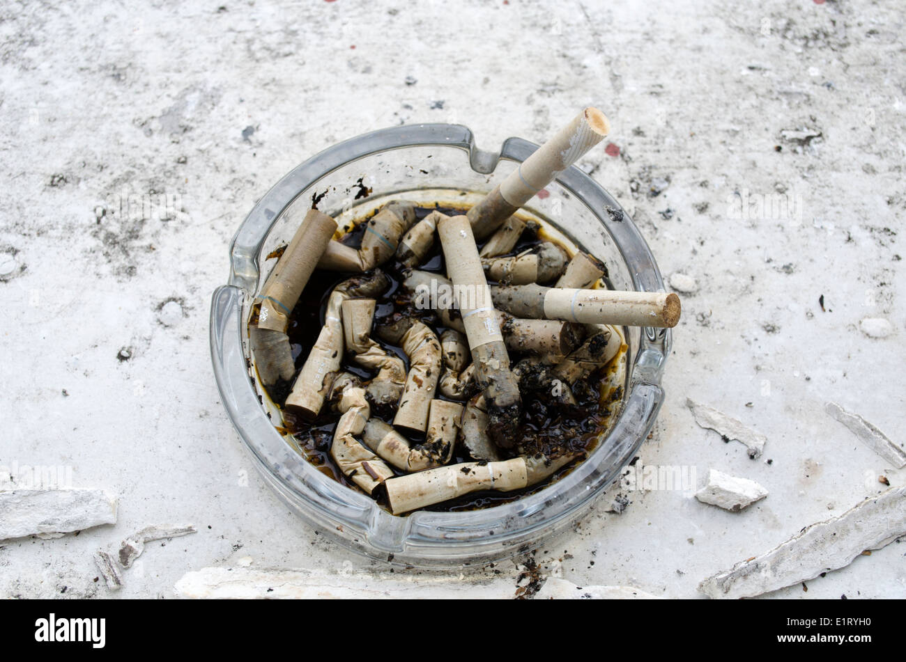 Ashtray Full of Cigarettes burnt butts wet and disgusting Stock Photo ...