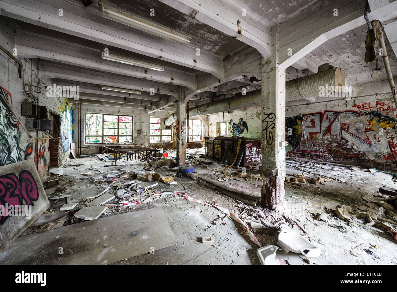 Messy abandoned factory room Stock Photo - Alamy