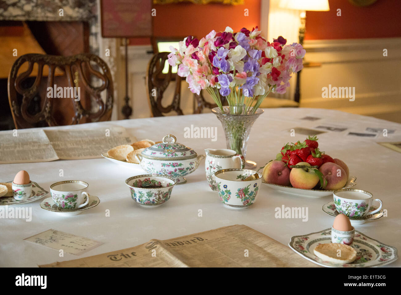 A breakfast table in a stately home with crockery and boiled eggs. An ...