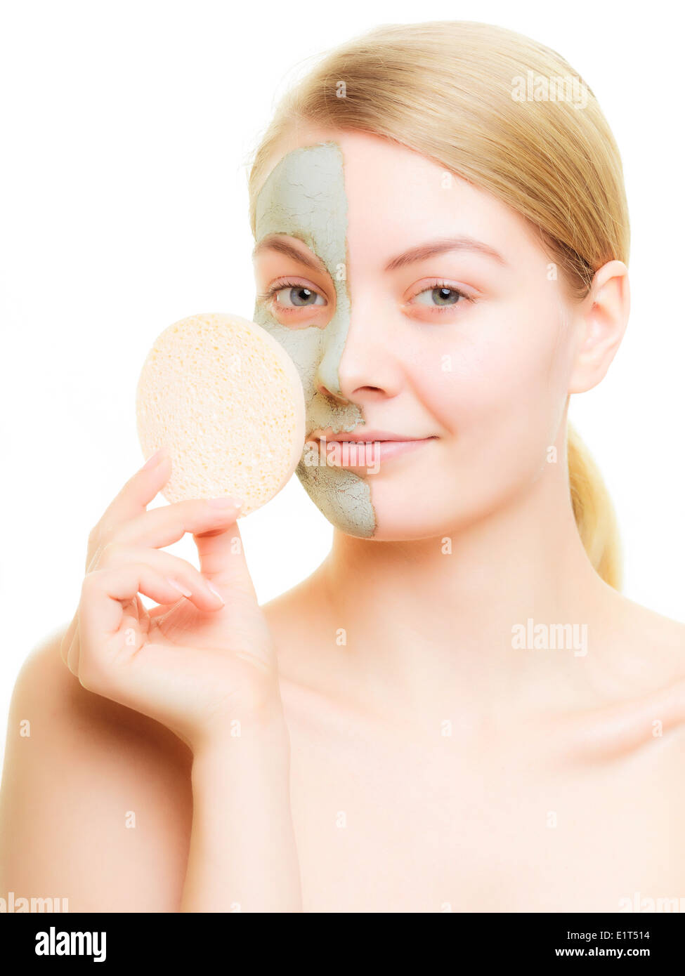 Skin care. Woman removing clay mud facial mask Stock Photo - Alamy