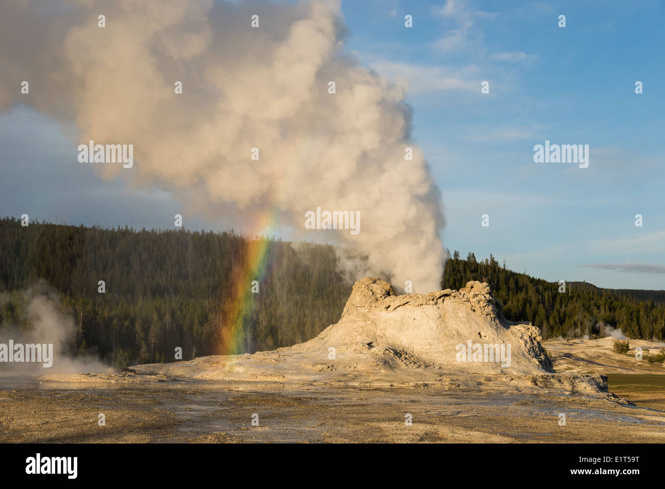 A beautiful rainbow formed during an eruption of the Castle Geyser ...