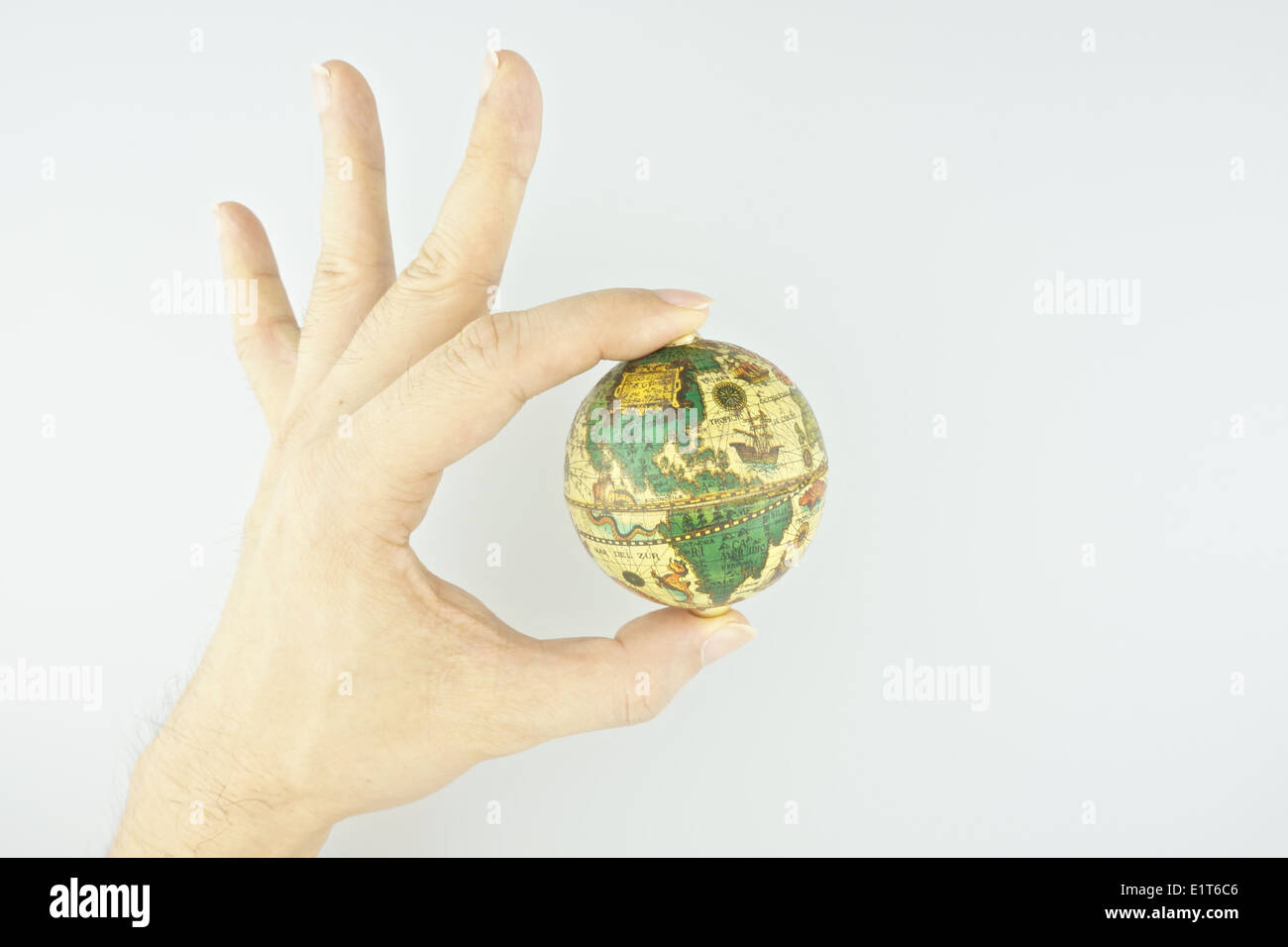 Hand of man make signal by ok with the globe isolated on white ...