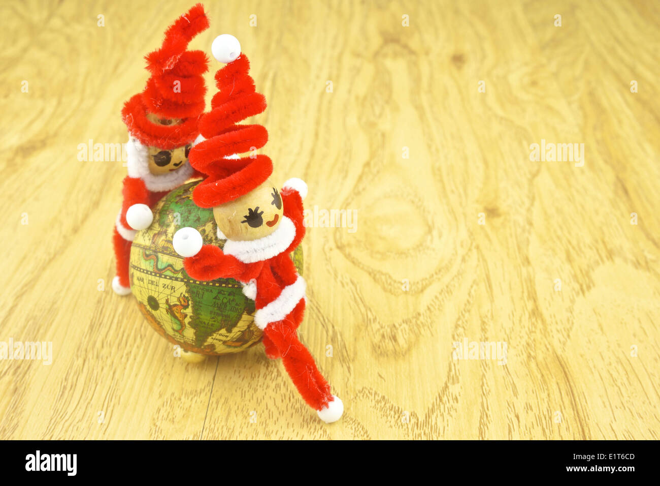 Santa rolling the globe on left with a wood background Stock Photo - Alamy