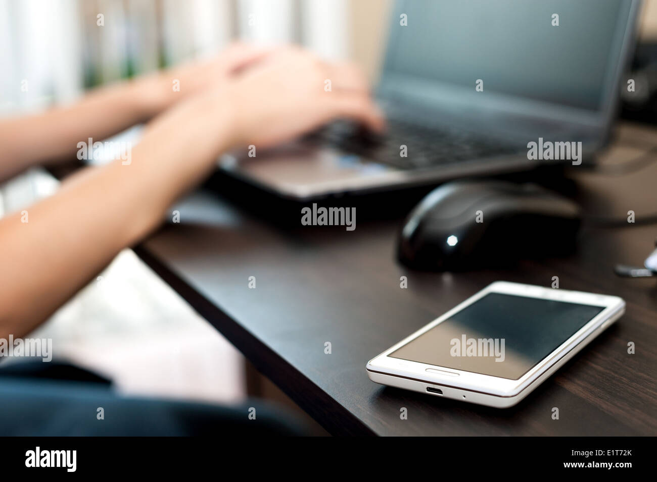 Cell phone on desk Stock Photo - Alamy