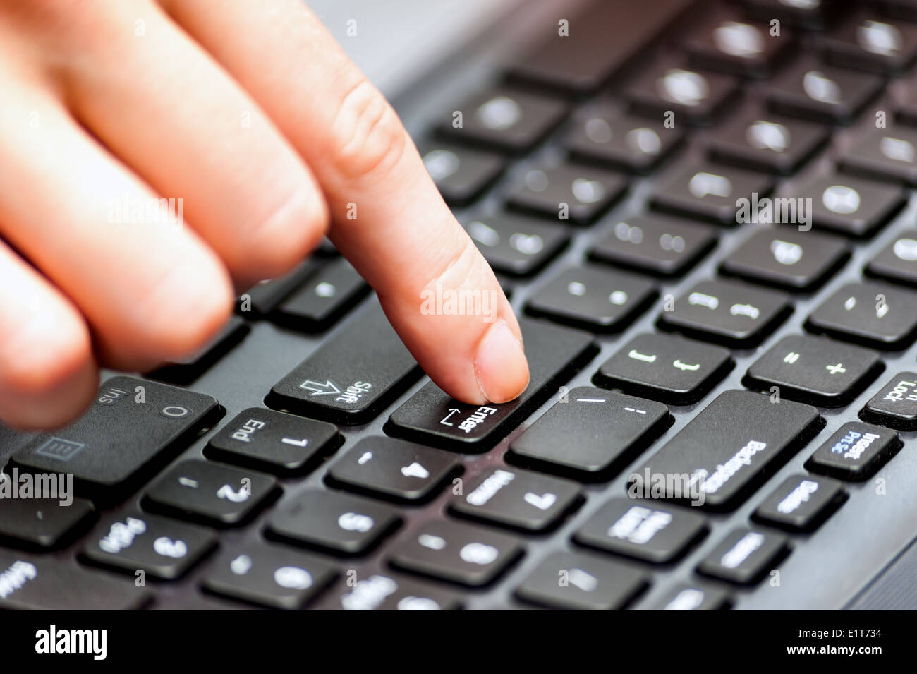 Finger pressing button on the keyboard Stock Photo - Alamy