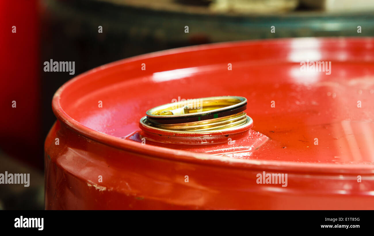 Car servicing oil change. Red oil barrel canister in mechanic garage ...