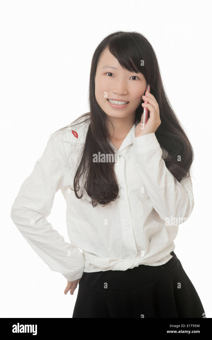 A beautiful Chinese woman talking on a smartphone while isolated on a ...