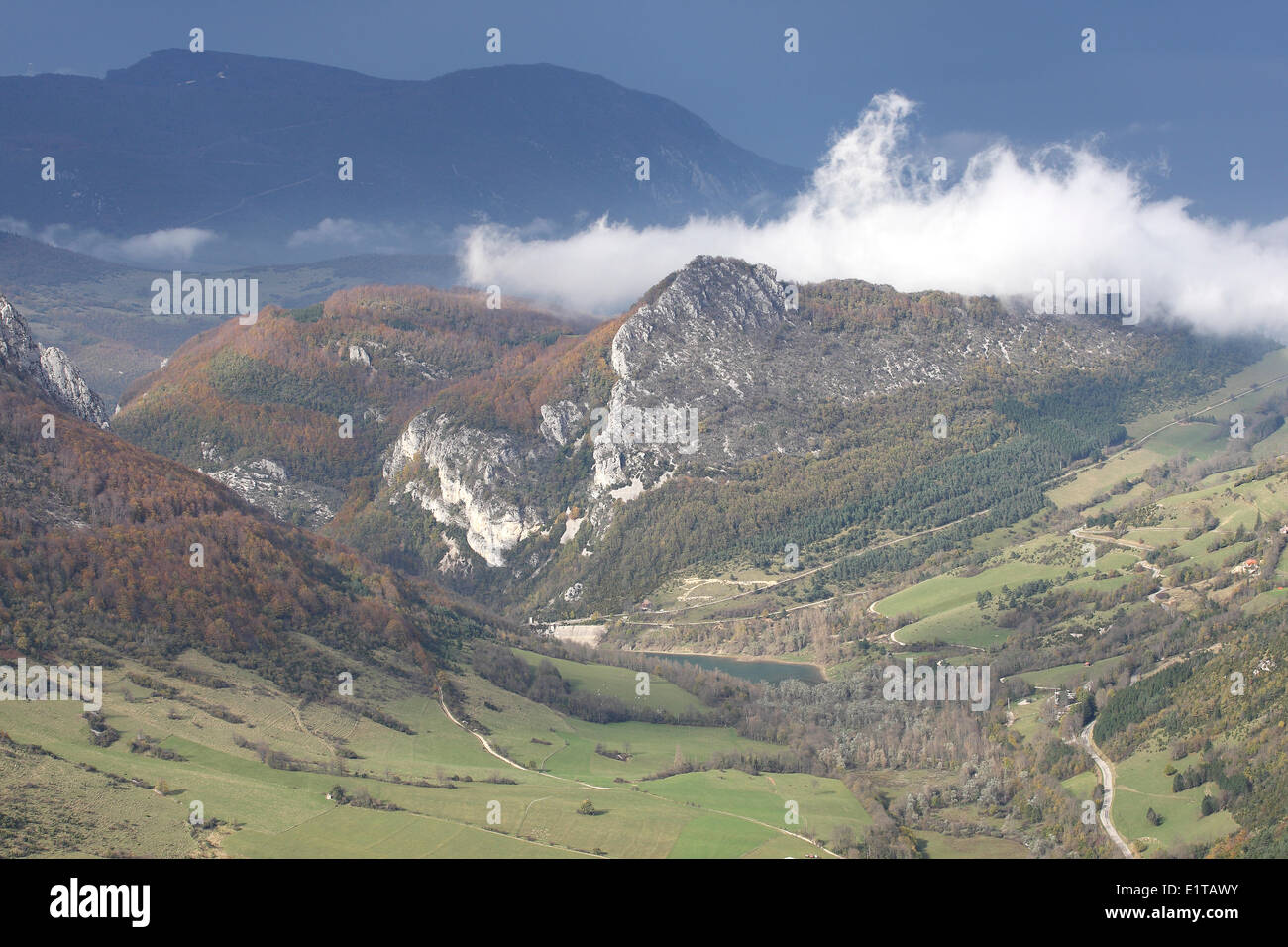 Mountain peaks and rocks in mist in autumn, Vercors national parc ...