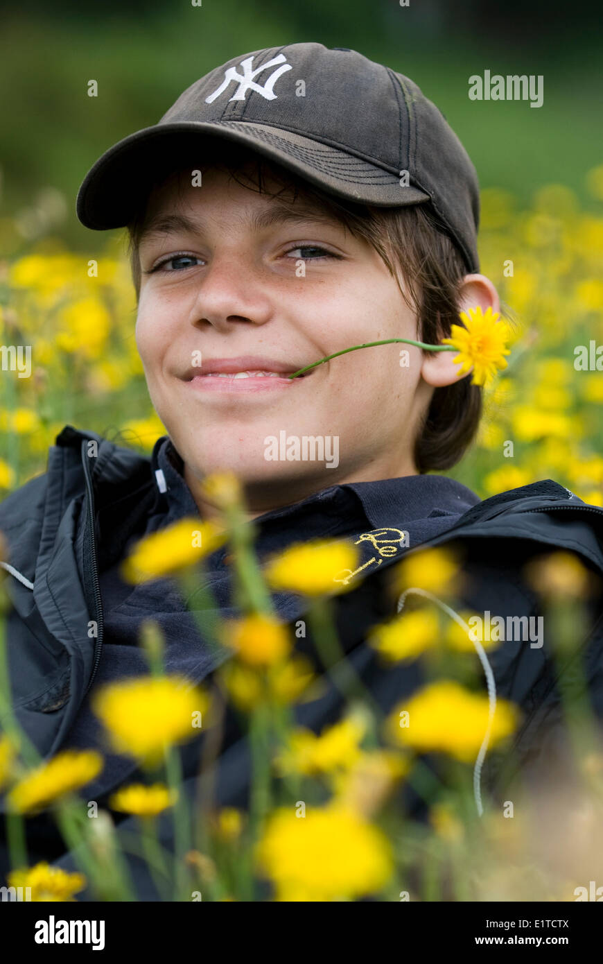 Boy lays at grass field Stock Photo - Alamy