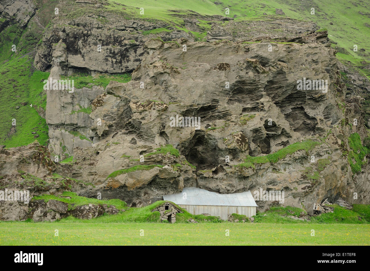 Shed build under overhanging cliff Stock Photo - Alamy