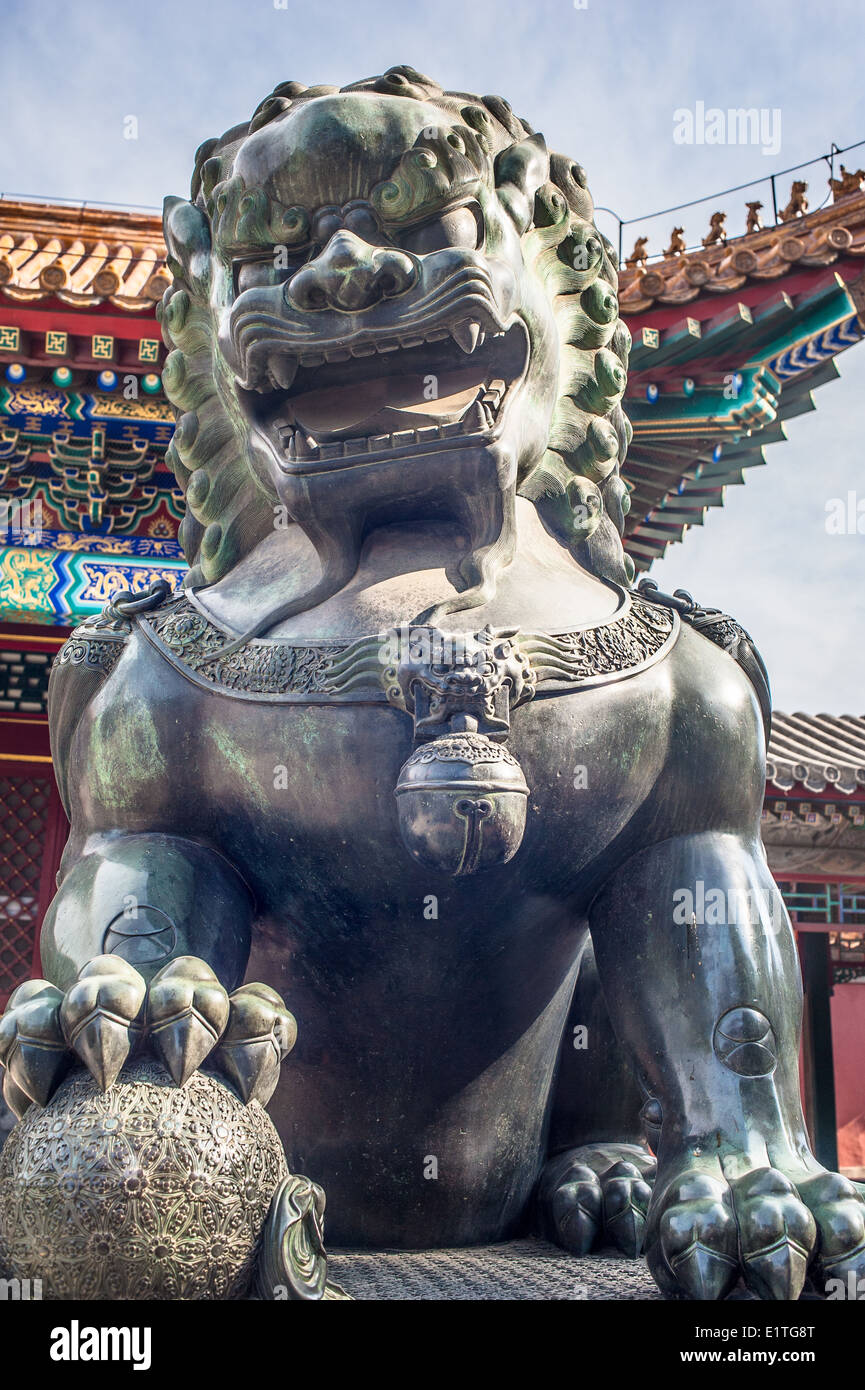 A copper lion standing in front of the ancient building, Summer Palace ...