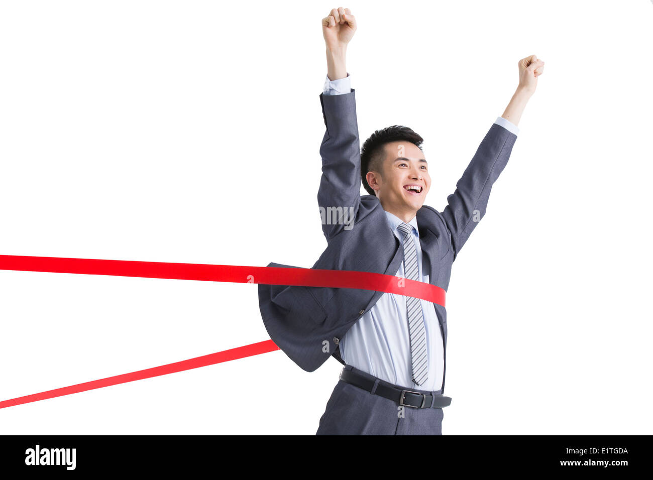 Excited businessman crossing the finish line Stock Photo - Alamy