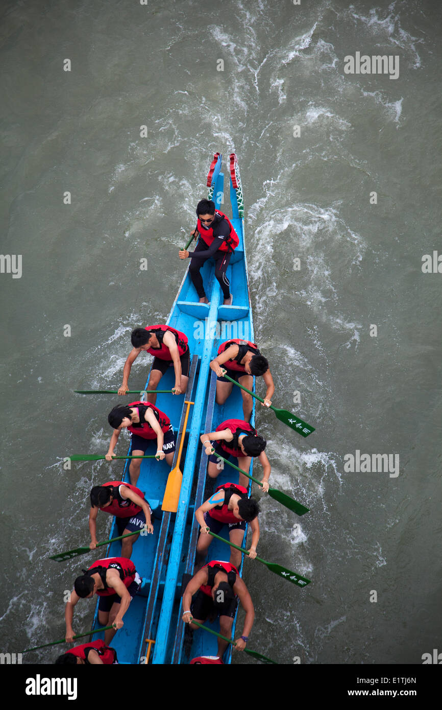 A competing team paddles down the river at the annual Dragon Boat ...