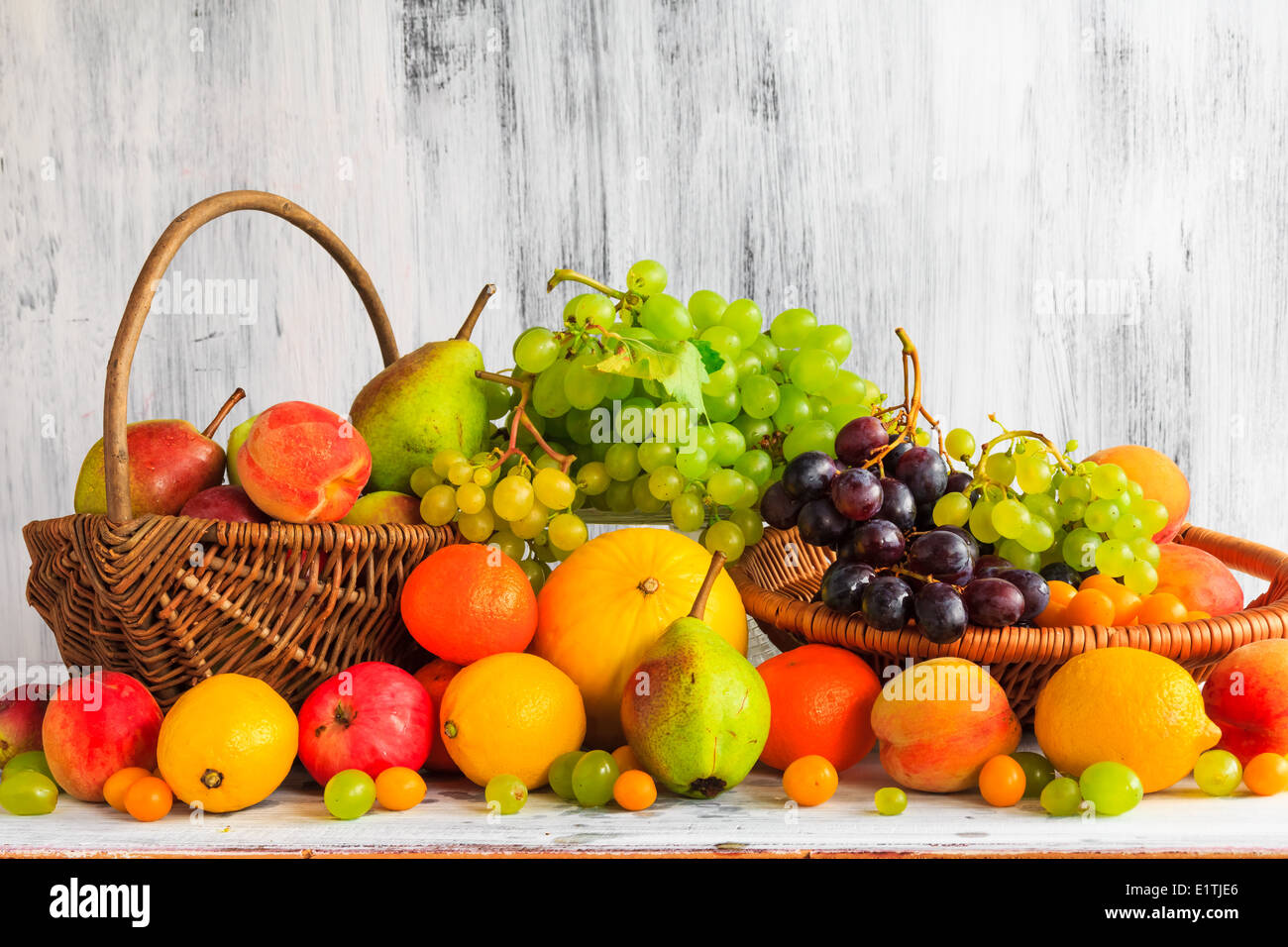 Wooden table full of fresh fruit in baskets Stock Photo - Alamy