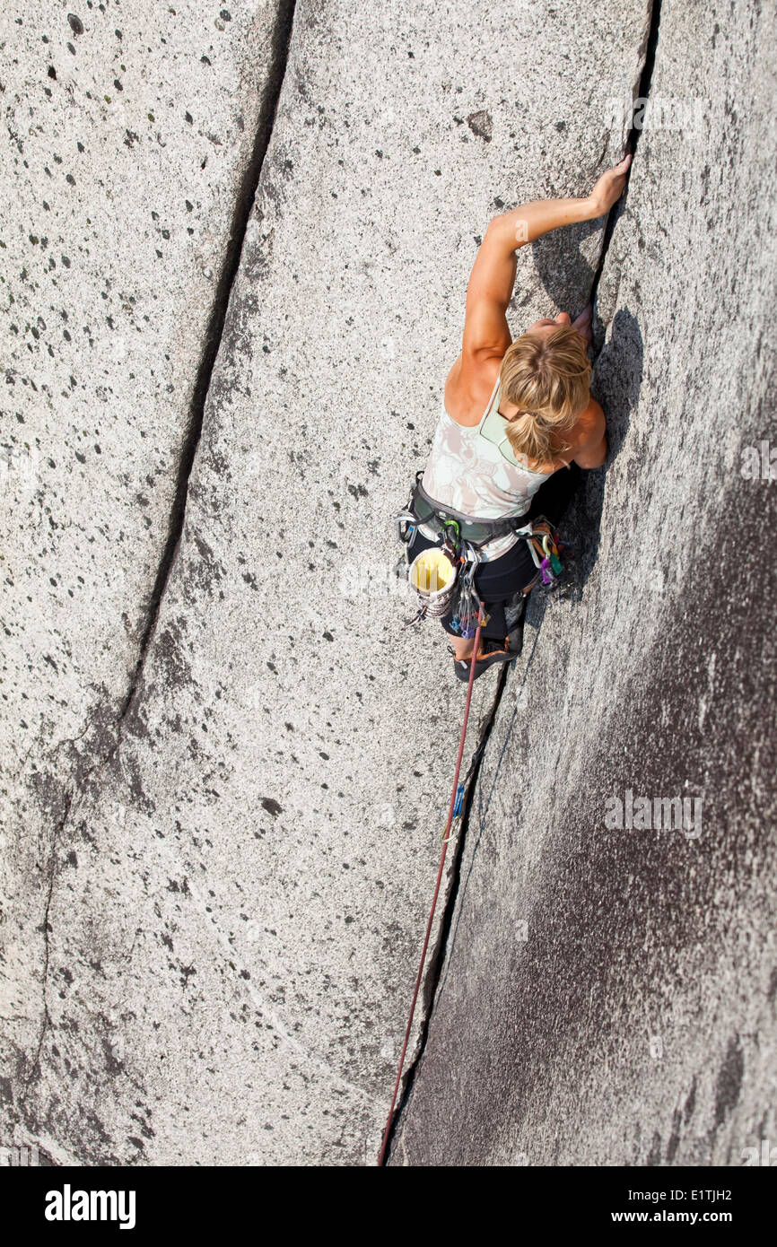 A strong female climber climbing Crescent Crack 10d, Squamish, BC Stock ...