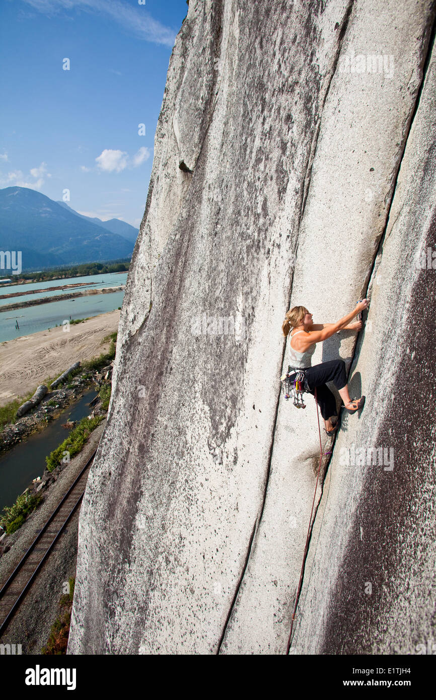 A strong female climber climbing Crescent Crack 10d, Squamish, BC Stock ...