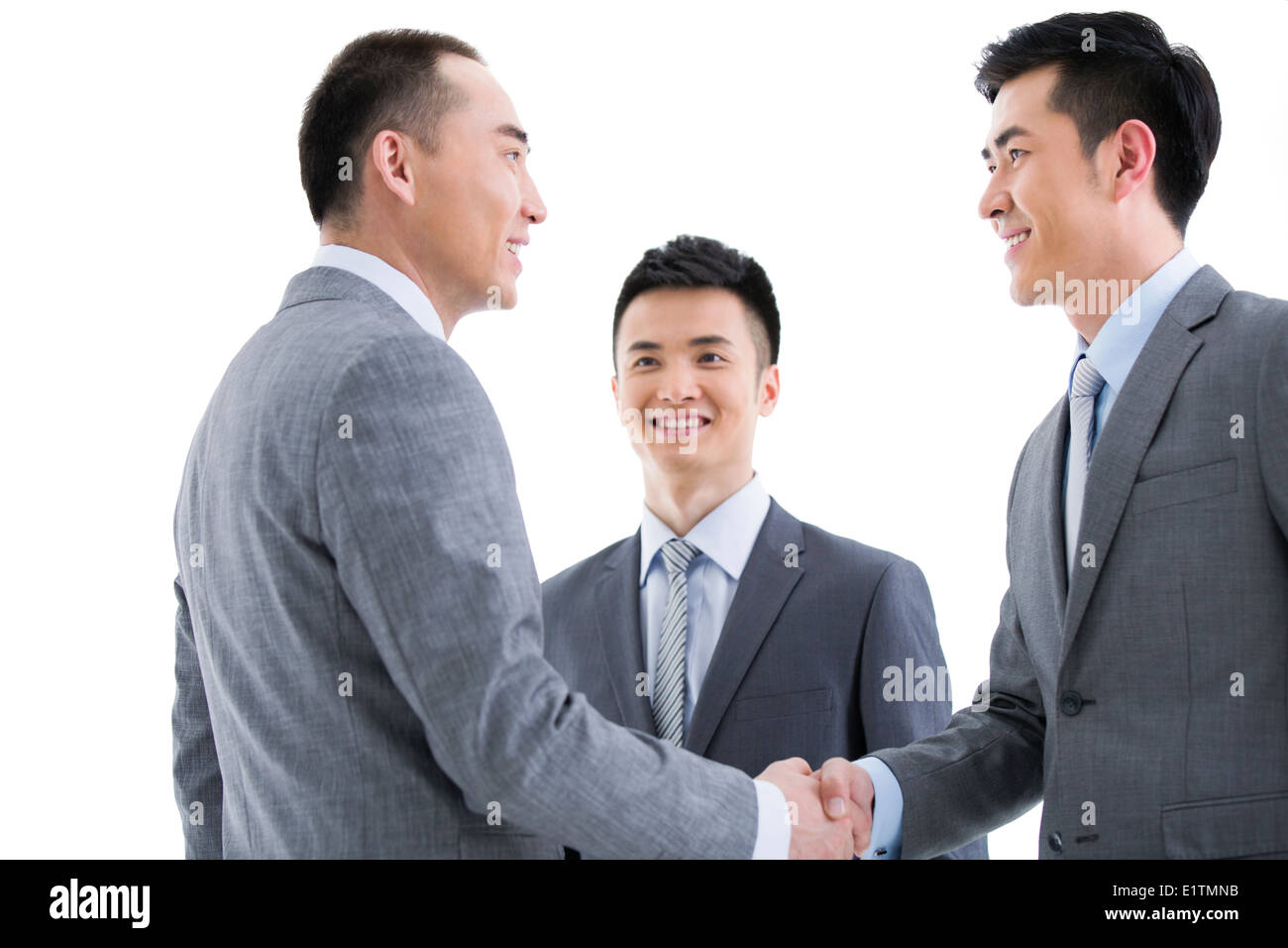Standing greeting shaking hands smiling leadership face to face hi-res ...