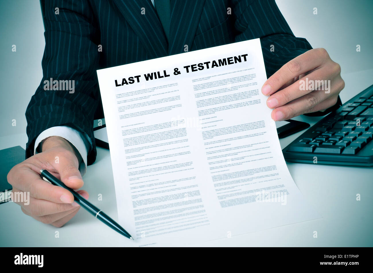 man in suit showing where the testator must sign in a last will and ...