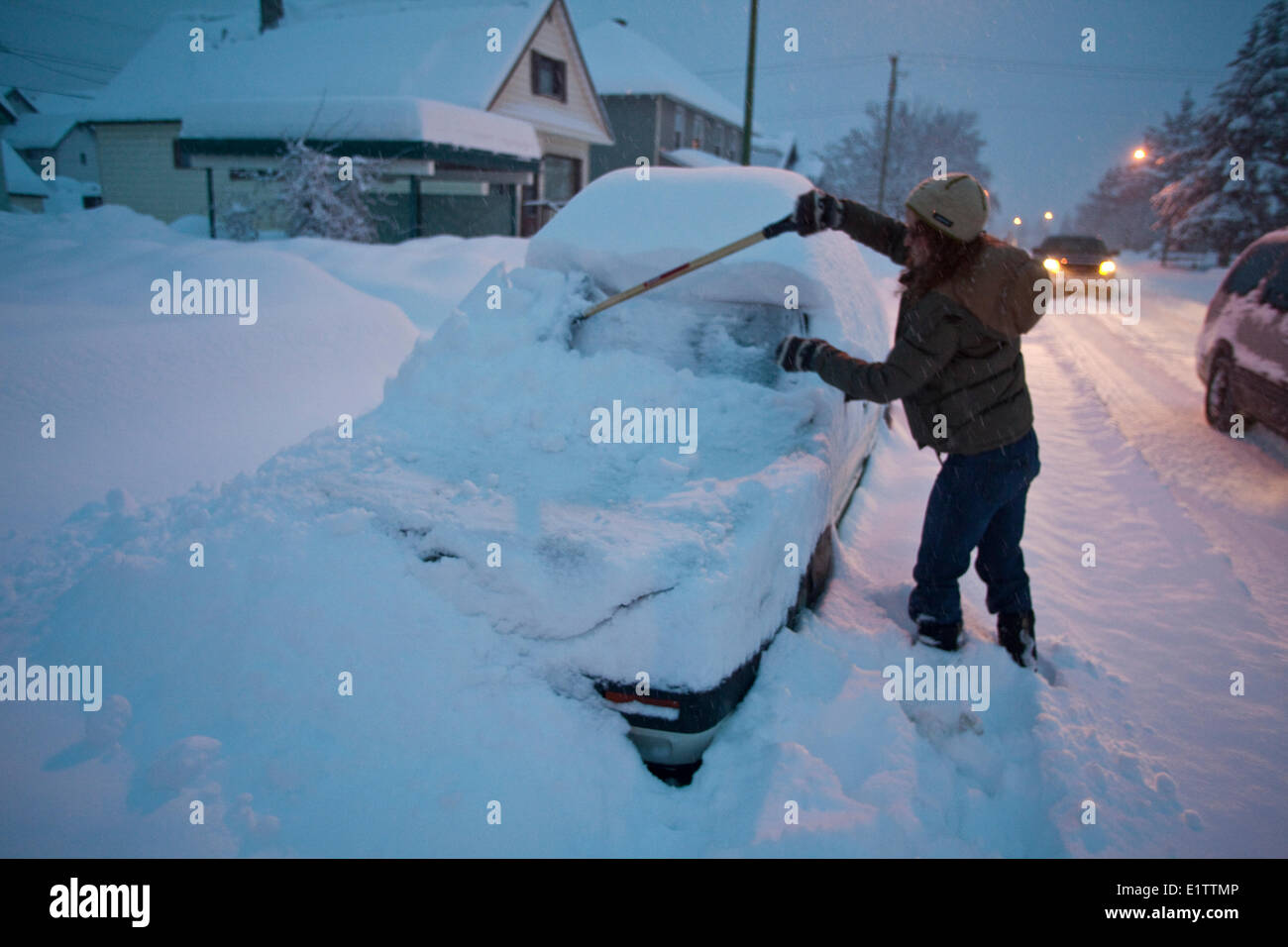 A woman shovels snow off her vehicle before work. Revelstoke, BC Stock Photo - Alamy