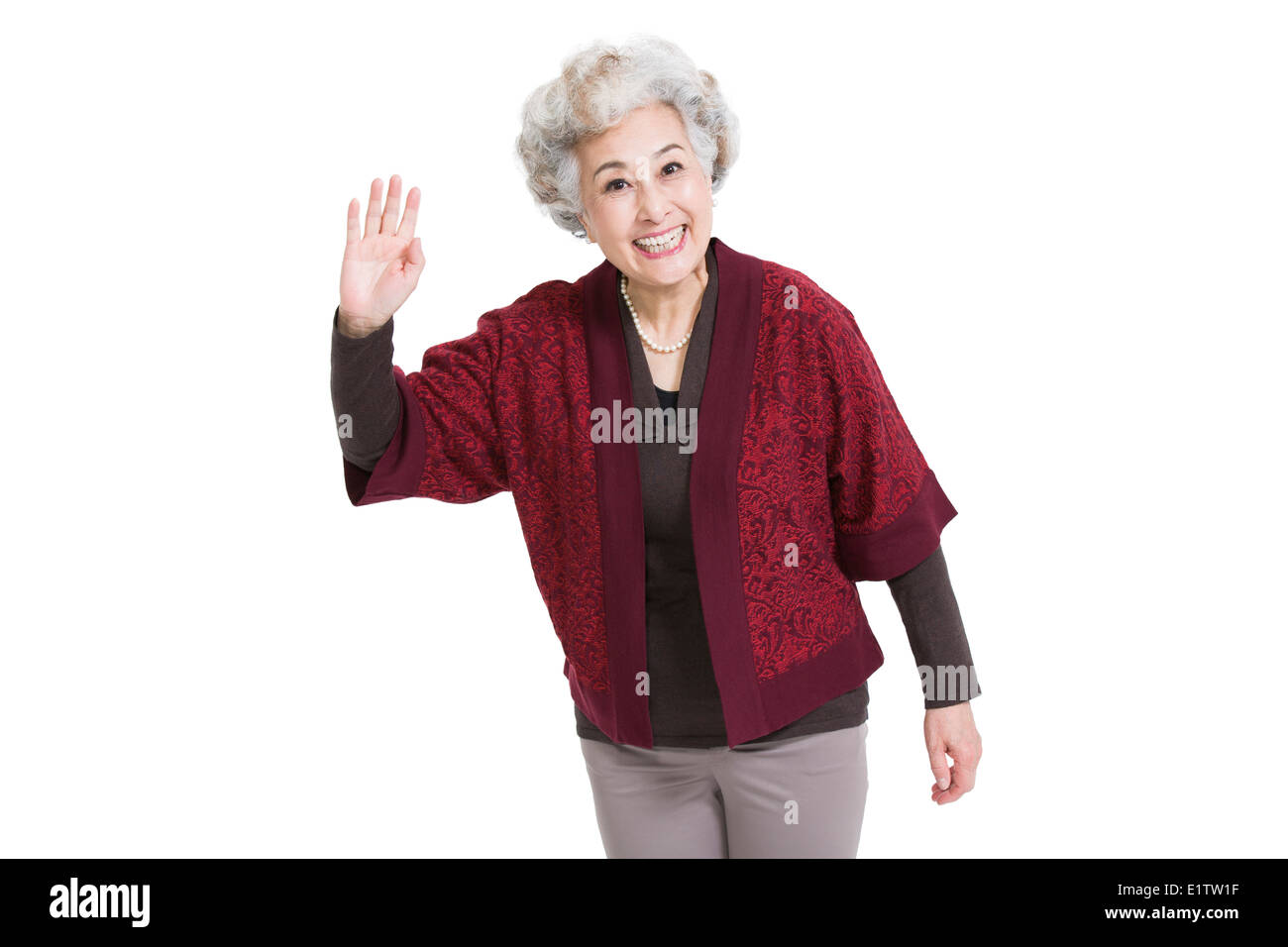 Cheerful senior woman waving Stock Photo - Alamy