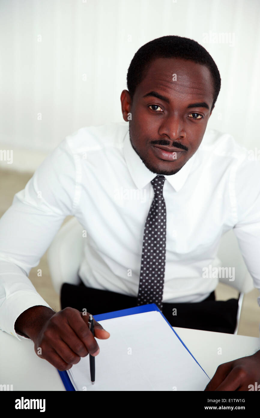 African man signing paper hi-res stock photography and images - Alamy