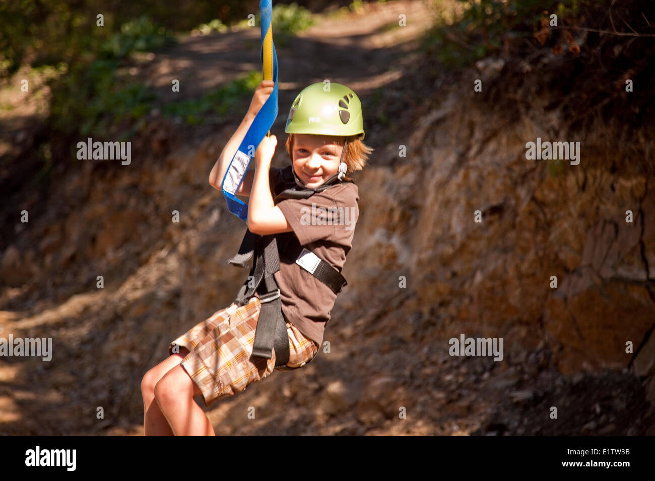 Young boy enjoys zip-line at Oyama Zipline, Okanagan Valley, BC, Canada ...