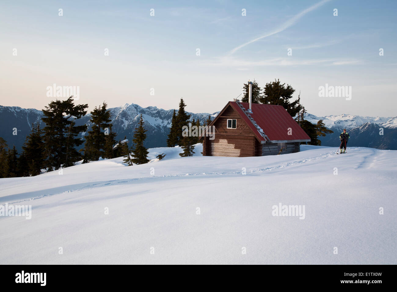 A skier enjoys the view of the coast mountains from Mt. Steele cabin in ...