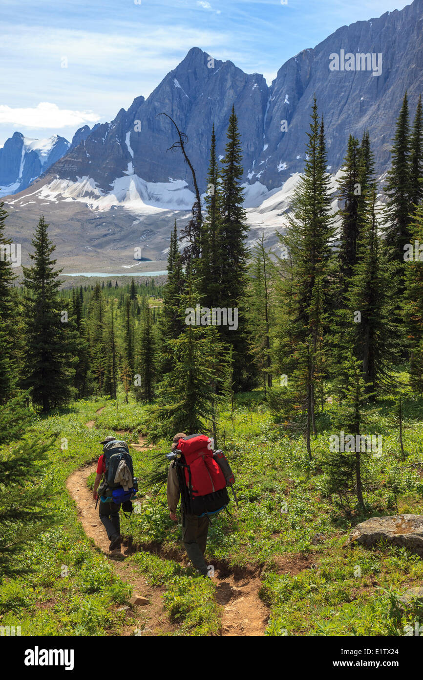 Two backpackers approach Wolverine Pass with the Rockwall Tumbling ...