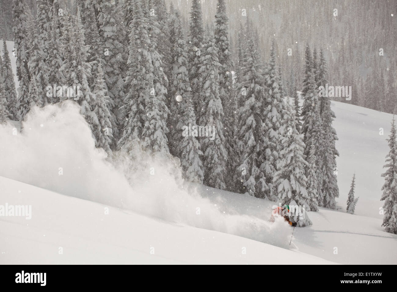 A man skiing deep powder while backcountry skiing at Sol Mountain ...