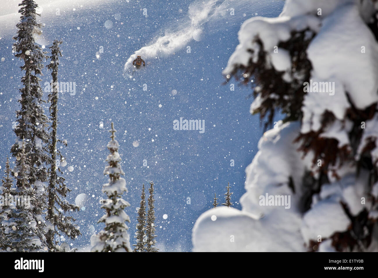 A man skiing deep powder while backcountry skiing at Sol Mountain ...