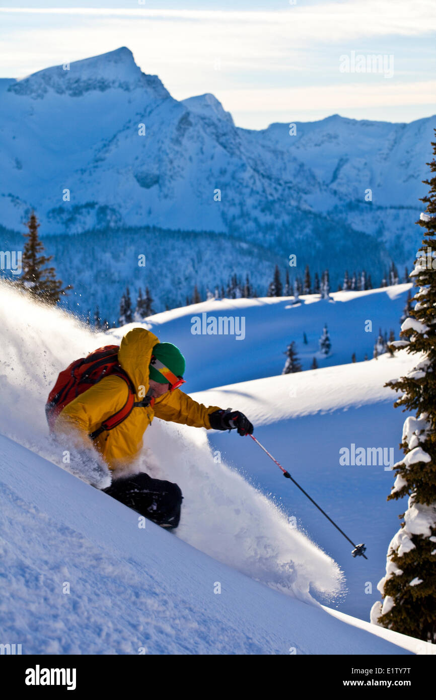 A man skiing deep powder while backcountry skiing at Sol Mountain ...