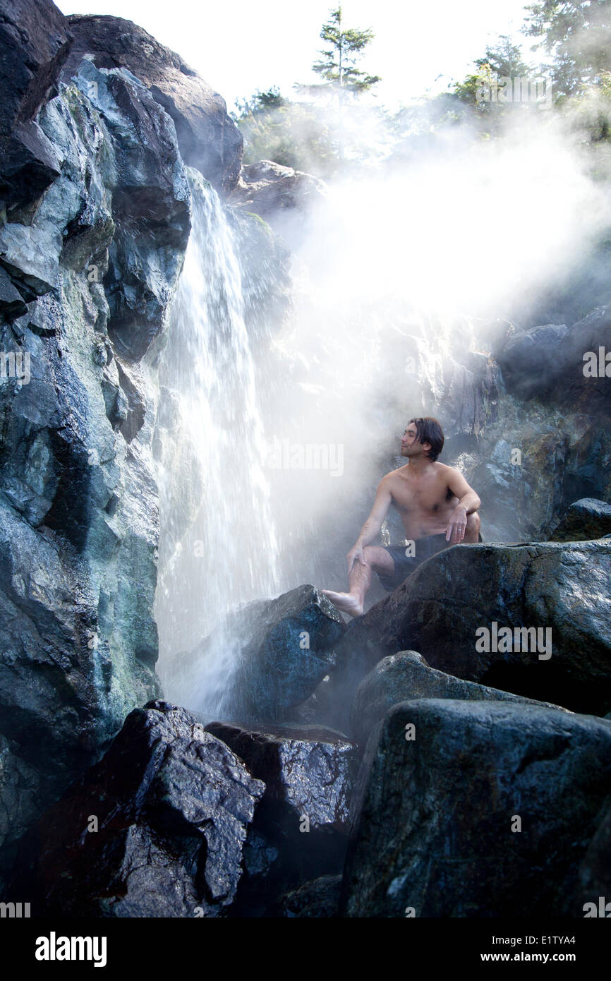 A visitor enjoys the steaming natural mineral hot springs at Hot ...