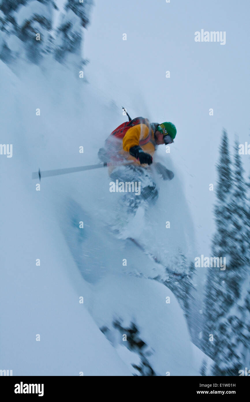A man skiing deep powder while backcountry skiing at Sol Mountain ...