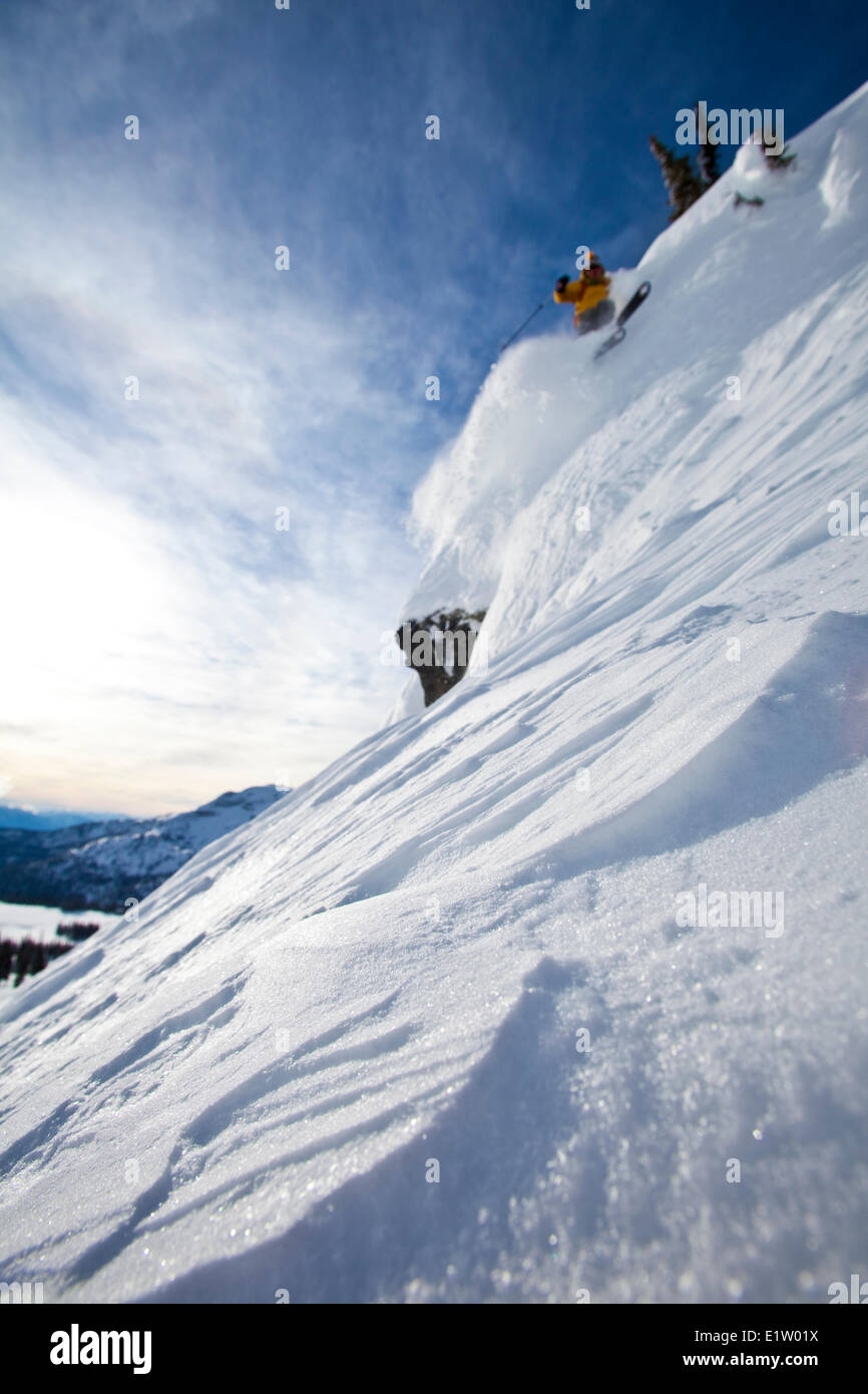 A man skiing deep powder while backcountry skiing at Sol Mountain ...