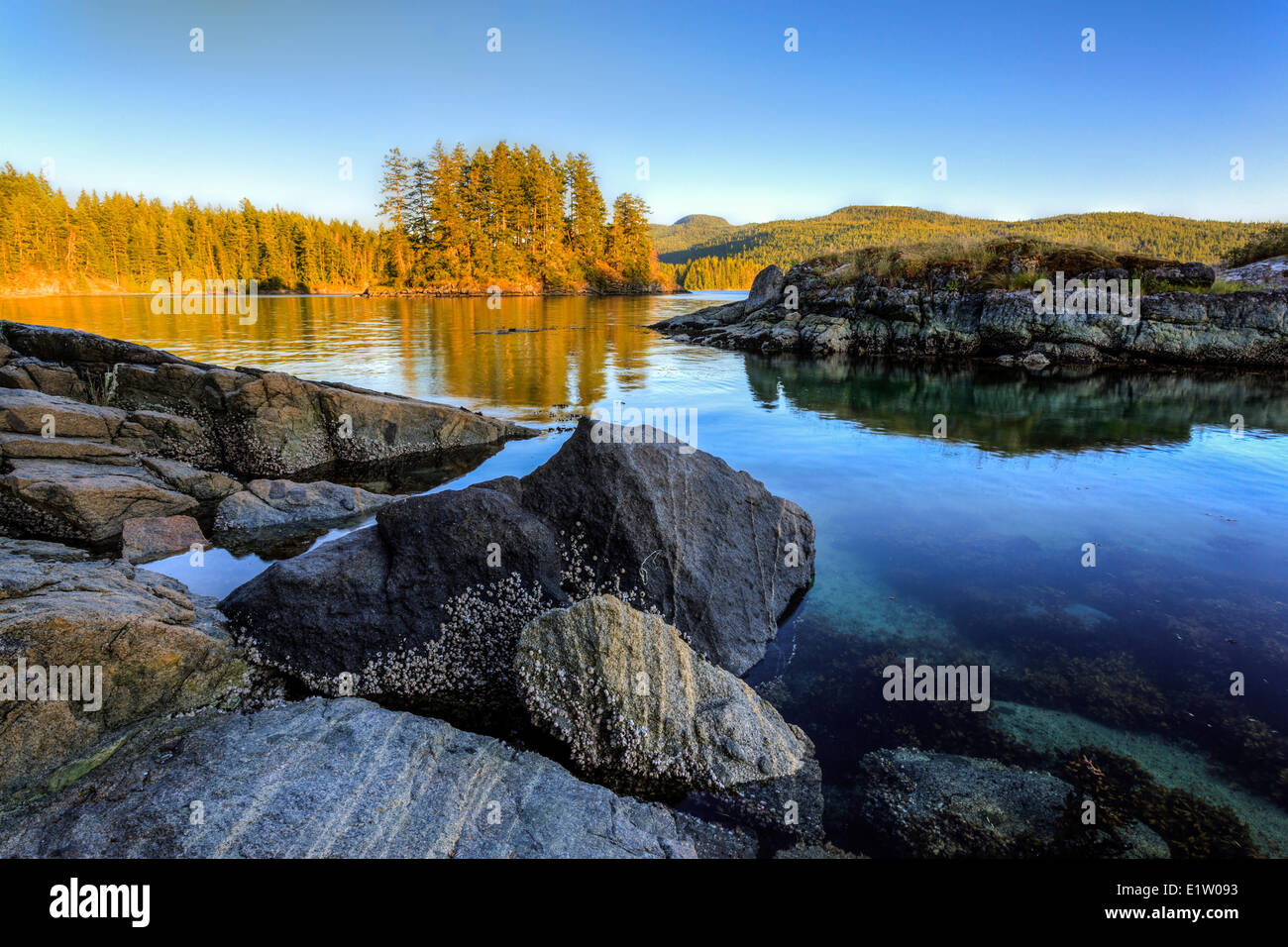 Sunset illuminates an islet in Octupus Island Provincial Marine Park ...