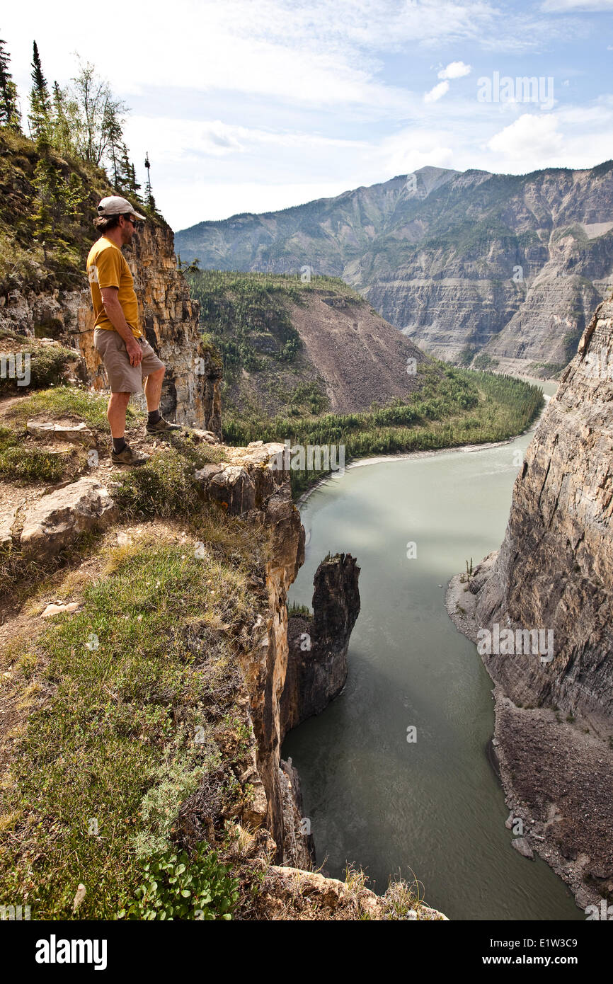 Man on cliff face above Nahanni River near 'The Pulpit' rock formation ...