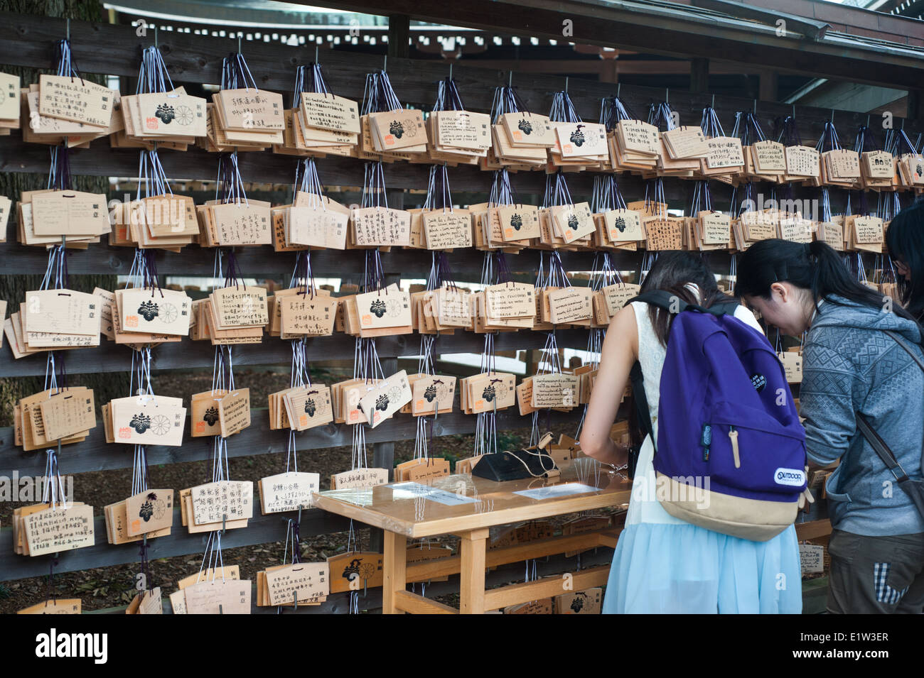 Tokyo Japan 2104 - Writing prayers and wishes on a wooden ema prayer ...